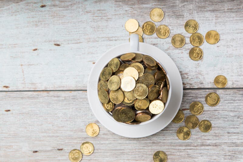 Gold coins on a coffee cup stock image. Image of coffee - 67631341