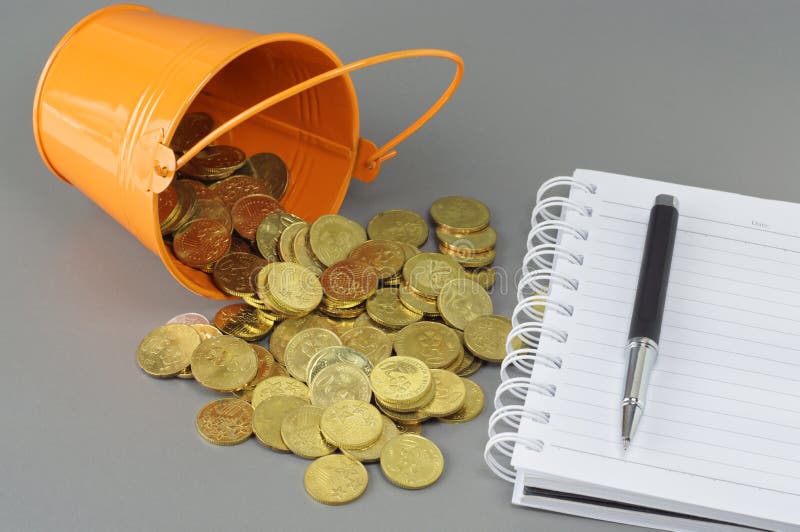 Gold Coins Notepad and Bucket - Business Concept Stock Photo - Image of ...