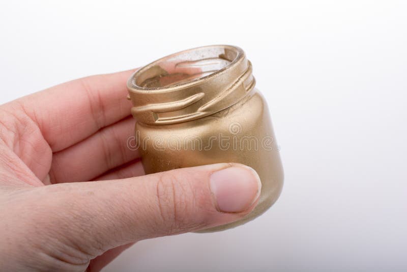 Gold Color Bottle in Hand on a Linen Canvas Stock Photo - Image of ...