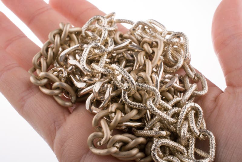Gold color chain in hand stock image. Image of escape - 66322873