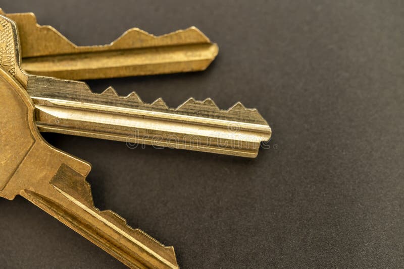 Gold Color Door Keys on a Gray Table Stock Photo - Image of business ...