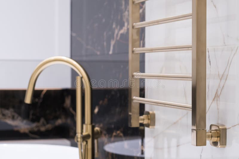 Gold-colored Heating Radiator on a Granite Wall in the Bathroom Stock ...