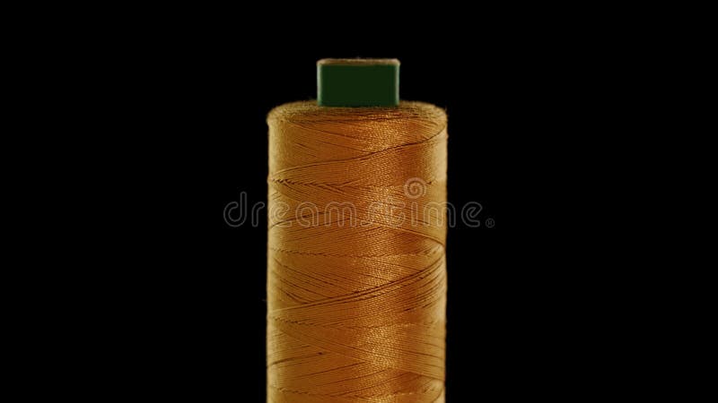 Gold Colored Sewing Thread on a Black Background Stock Video - Video of ...