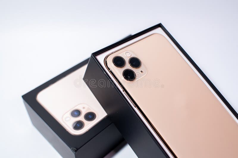 Gold-colored Smartphone with Three Cameras on a White Background. Stock ...