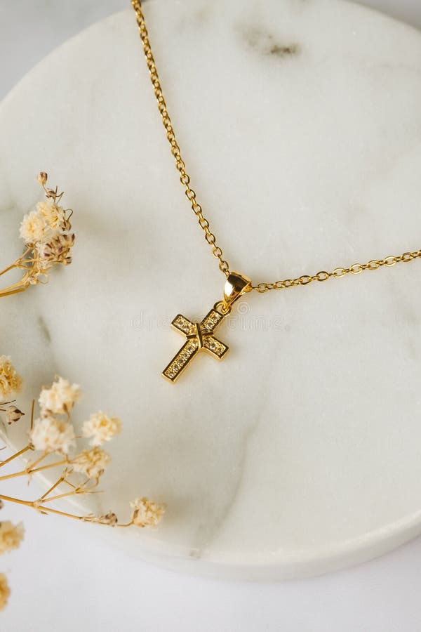 Gold Cross Necklace on a Marble Surface Stock Image - Image of necklace ...