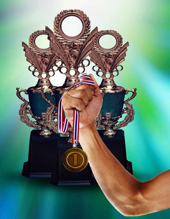 Gold Cup Championship and Hand Holding Gold Medal Stock Photo - Image ...