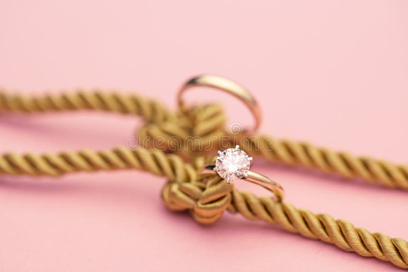 Gold Engagement Diamond Ring on Ropes with Knot Stock Image - Image of ...