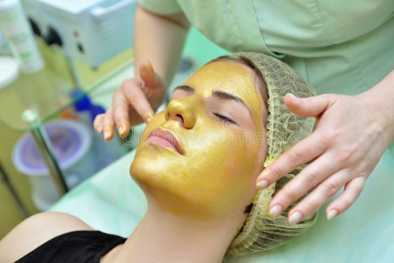 Woman with gold face mask stock image. Image of golden - 12099351
