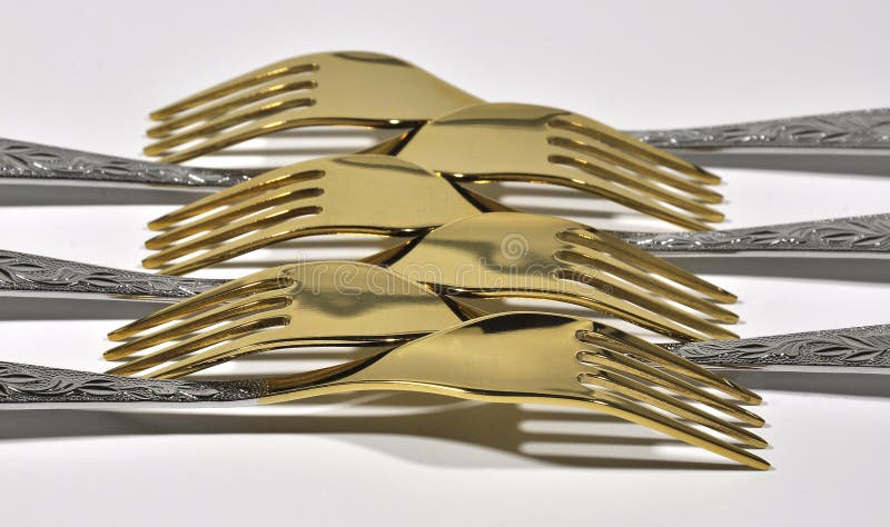Two gold forks isolated stock photo. Image of gold, food - 18335660