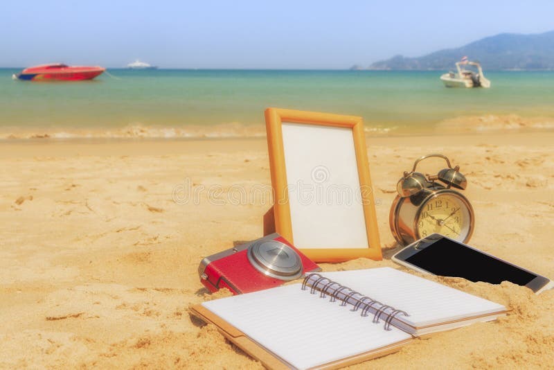 Gold Frame on the Beach with Camera,mobile ,notebook and Phone C Stock ...