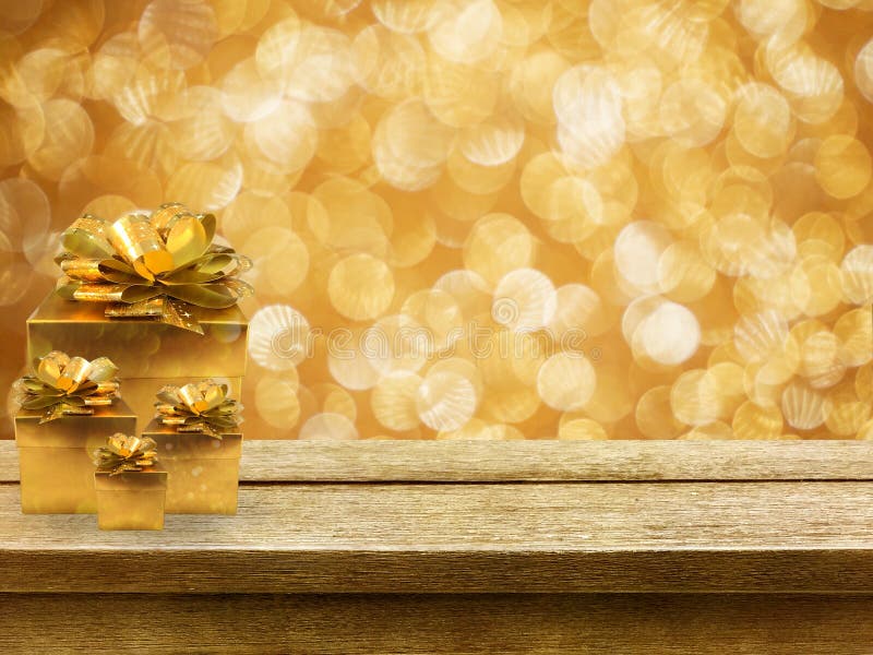 Gold Gift Boxes and Ribbon on Wood Table, Bokeh Background Stock Image ...