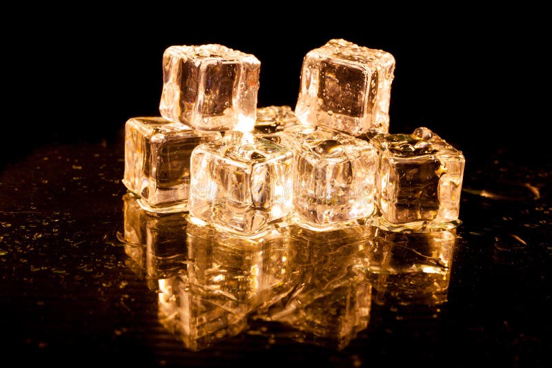Gold Ice Cubes on Black Background Stock Image - Image of drink, light ...