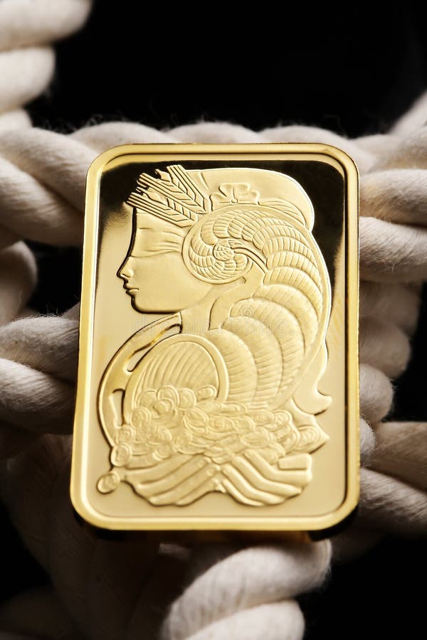 Gold ingot on white rope stock photo. Image of finance - 25887834