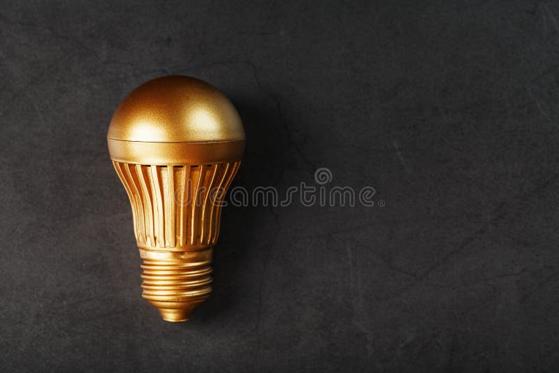 Gold Light Bulb on a Black Textured Background. Stock Photo - Image of ...