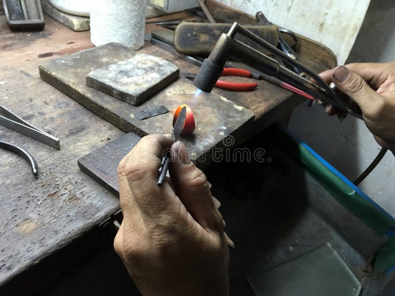 A Gold Making Worker is Firing on the Gold Ring To Adjust Its Si Stock ...