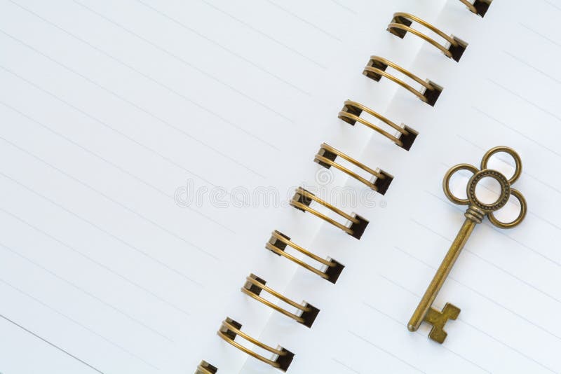 A Gold Metal Key on White Paper Stock Photo - Image of textbook, page ...