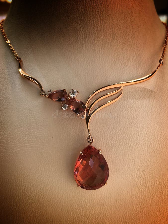 Gold Necklace with Sultanite on a Light Background. Stock Image - Image ...