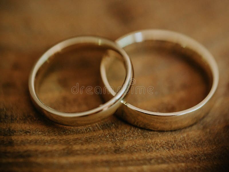 Gold Pair of Ring on Wooden Table Stock Photo - Image of jewellery ...