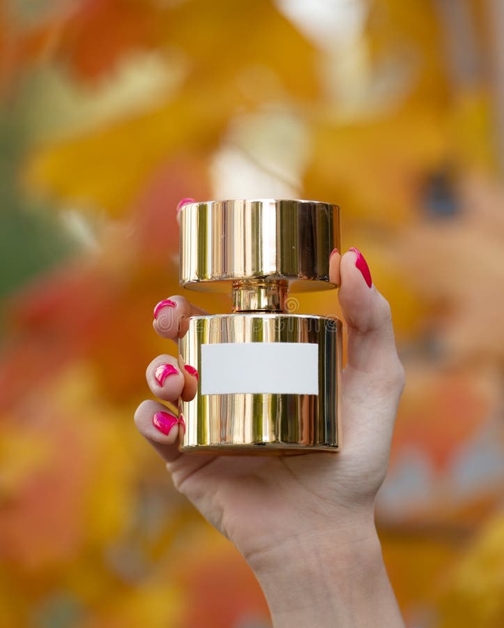 Gold Perfume Bottle in Hand. Presenting Perfume Bottle. Presenting ...