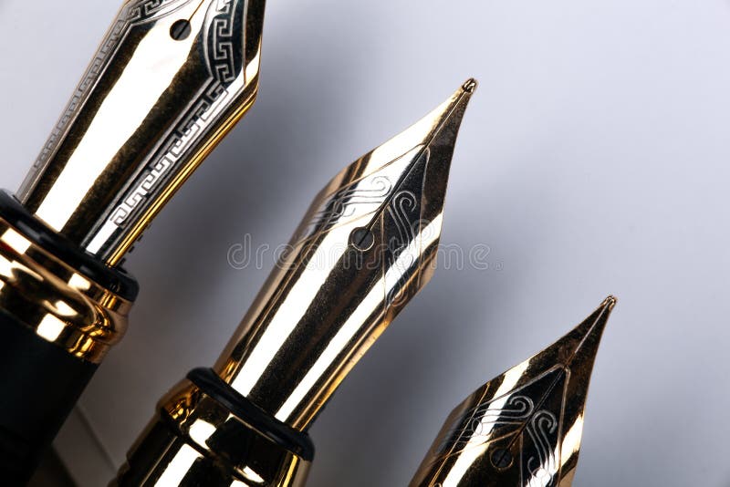 Gold Plated Fountain Pens Closeup on a Grey Background Stock Image ...