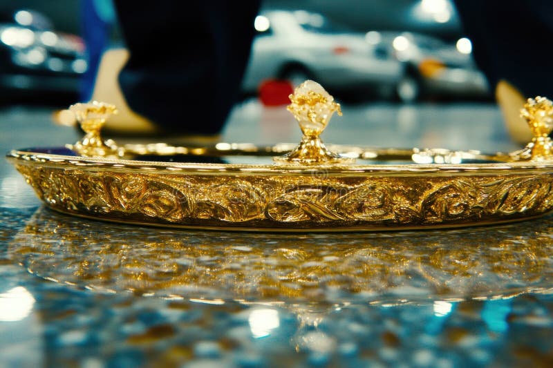 Gold Platter with Candle Holders on Reflective Surface in Parking ...