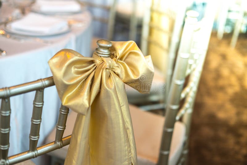 Gold Ribbon Decoration on Wedding Chairs Stock Photo - Image of ...