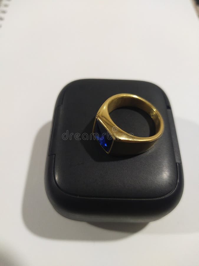 Gold Ring with a Blue Gemstone on a Black Display Box Stock Photo ...