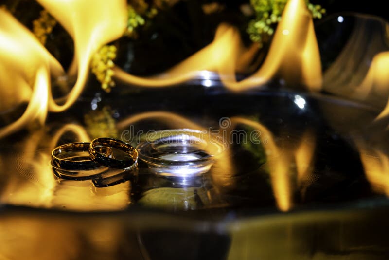 Gold Ring on Glass with Fire in the Background Stock Image - Image of ...