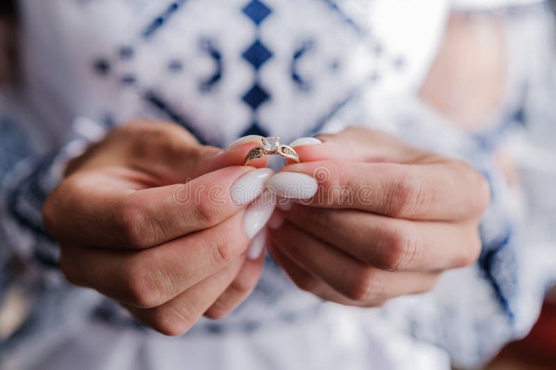 Gold Ring with a Stone in the Hands of the Bride. Diamond Ring in the ...
