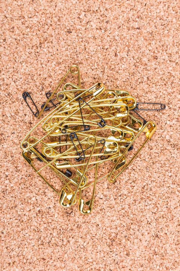 Stack of Gold Colored Safety Pins on Cork Stock Photo - Image of needle ...