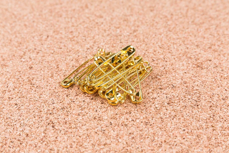 Stack of Gold Colored Safety Pins on Cork Stock Photo - Image of brass ...