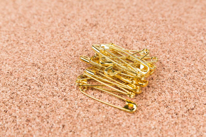Stack of Gold Colored Safety Pins on Cork Stock Photo - Image of shiny ...