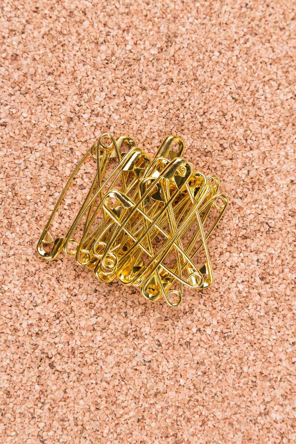Stack of Gold Colored Safety Pins on Cork Stock Image - Image of ...