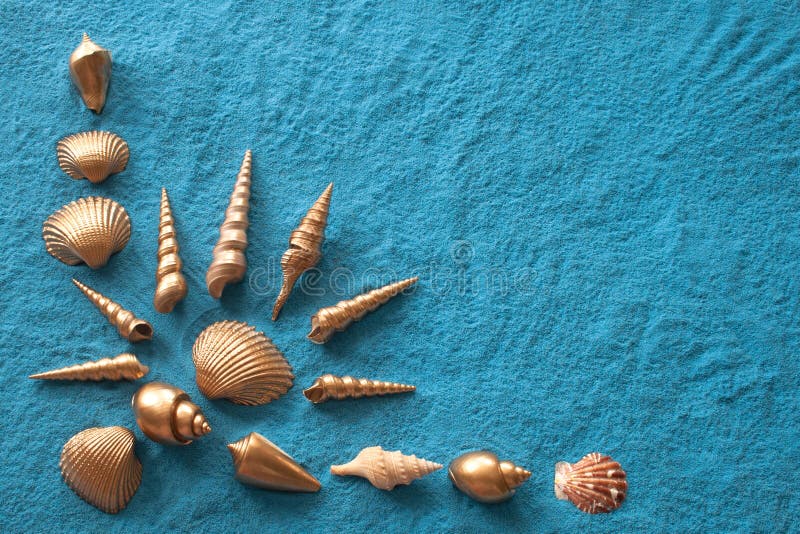 Gold Shells on Blue Sand stock photo. Image of right - 22638356
