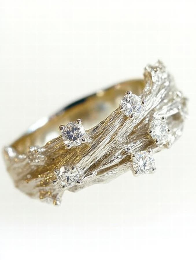 A Gold and Silver Ring with a Tree Branch Design and Diamonds Stock ...