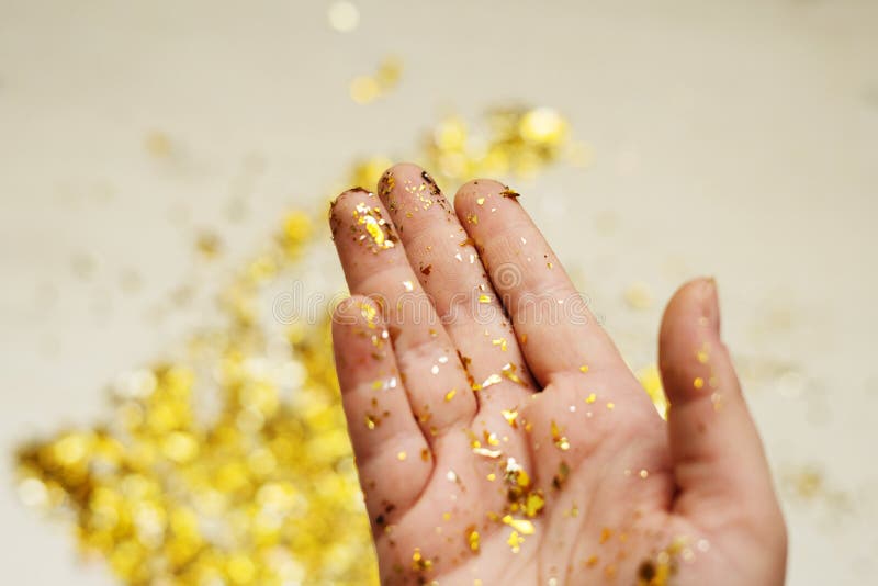 Gold Sparkles in the Palm of Your Hand Stock Photo - Image of ...