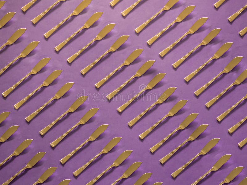 Gold Spread Knives Pattern on Pink Stock Image - Image of small ...