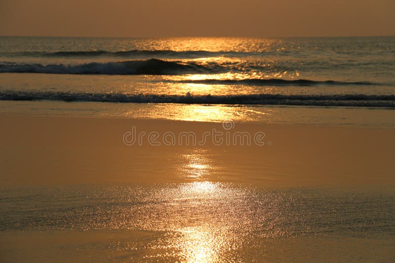 Gold sunrise on the beach stock photo. Image of ocean - 83909644