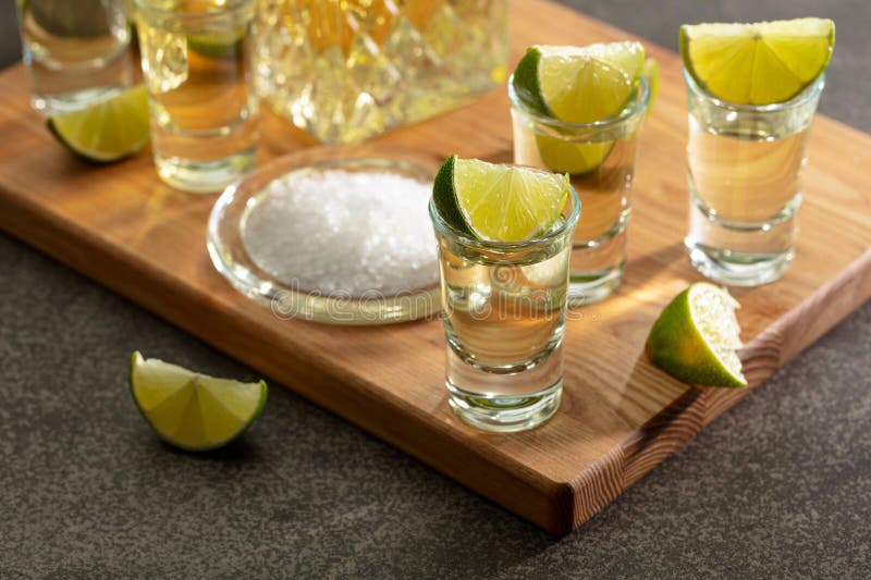 Tequila with Sea Salt and Lime Slices on a Cutting Board Stock Image ...
