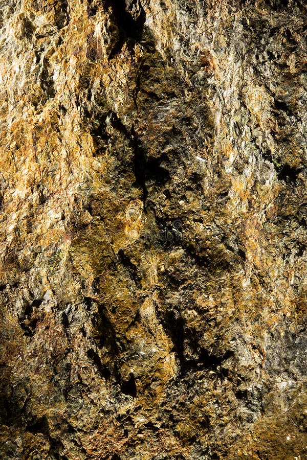 Gold textured rock surface stock image. Image of gold - 100944185