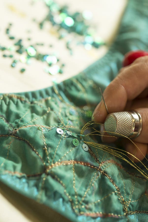 Gold Thread through a Sequin on Green Garment Stock Image - Image of ...