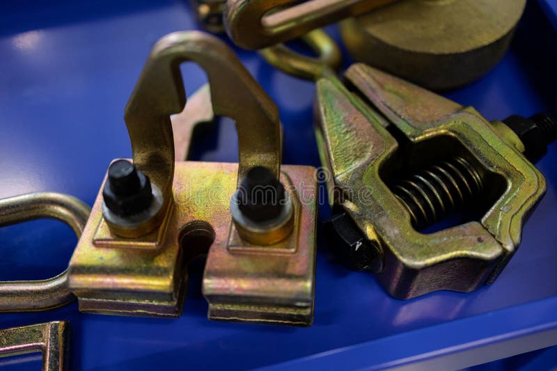 Gold-toned Mechanical Components Arranged on a Blue Workbench Surface ...
