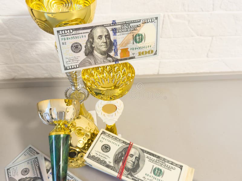 Gold Trophy Cup on a Bunch of Cash Stock Photo - Image of currency ...