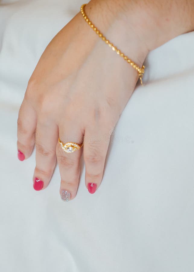 Gold Wedding Ring and Bracelet. Stock Photo - Image of bouquet ...