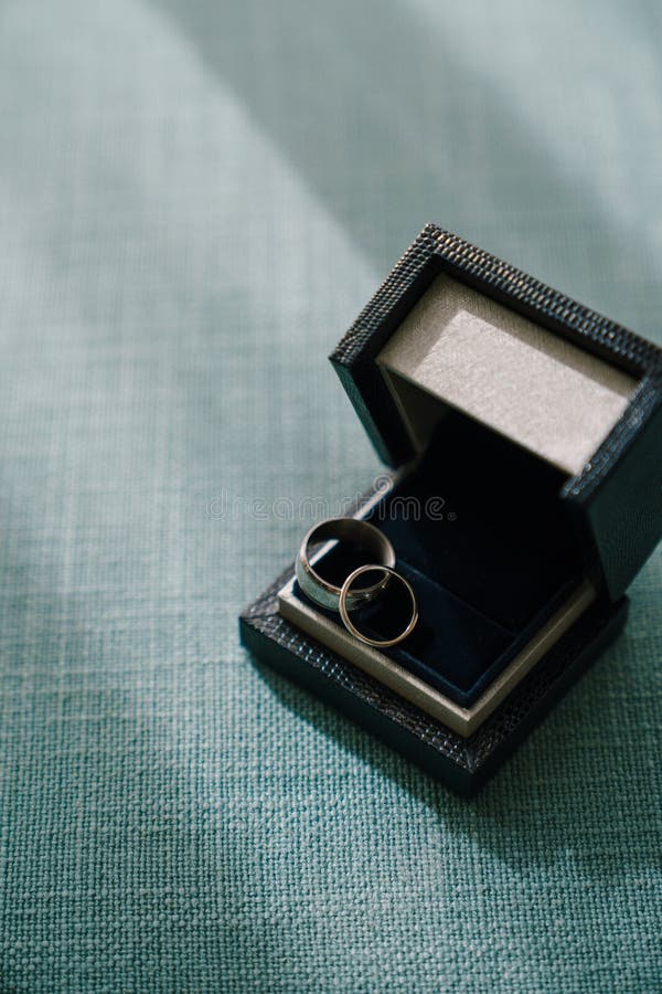 Gold Wedding Rings in a Black Box on a Fabric with Patterns. Stock ...