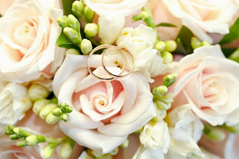 Gold Wedding Rings on Bouquet of Flowers for the Bride Stock Image ...
