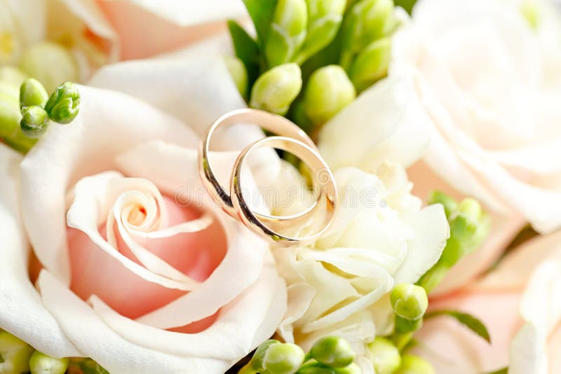 Gold Wedding Rings on Bouquet of Flowers for the Bride Stock Image ...
