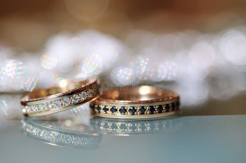 Gold Wedding Rings Laying on the Table Stock Image - Image of elegant ...