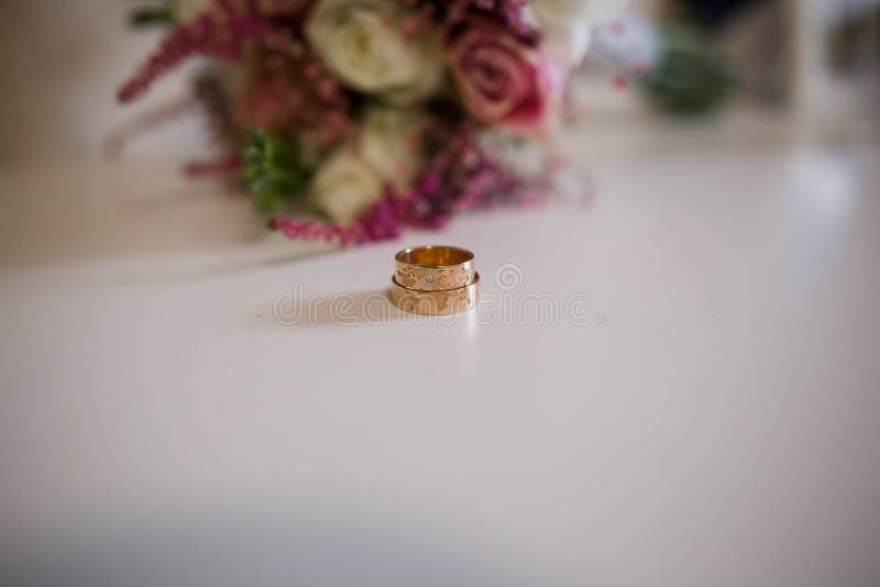 Gold Wedding Rings on the Table Stock Image - Image of background ...