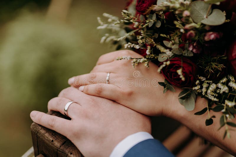 Gold Wedding Rings on Two Hands with Flower Stock Photo - Image of ...
